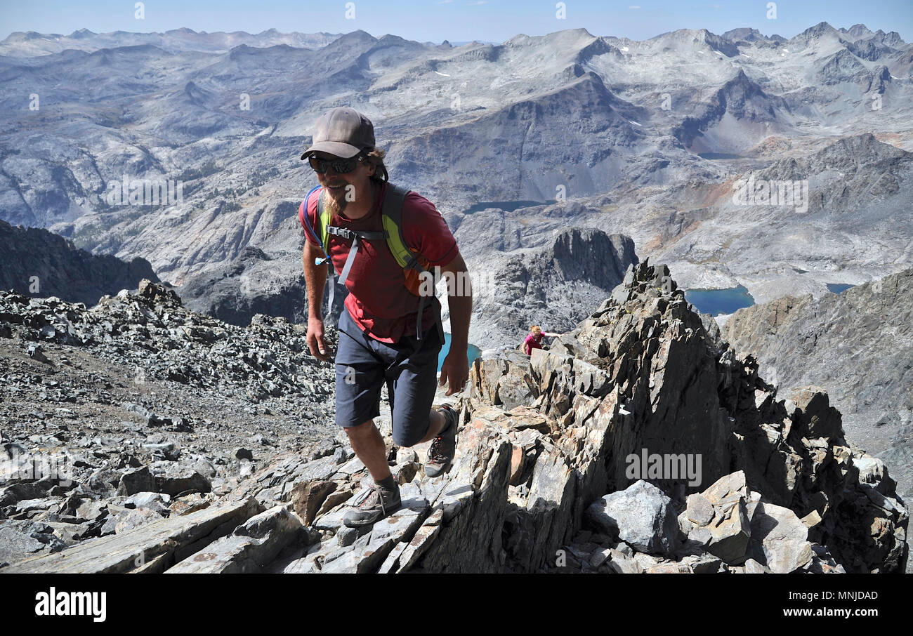 Backpackers climbing Mt Ritter on trek of Sierra High Route in Minarets ...