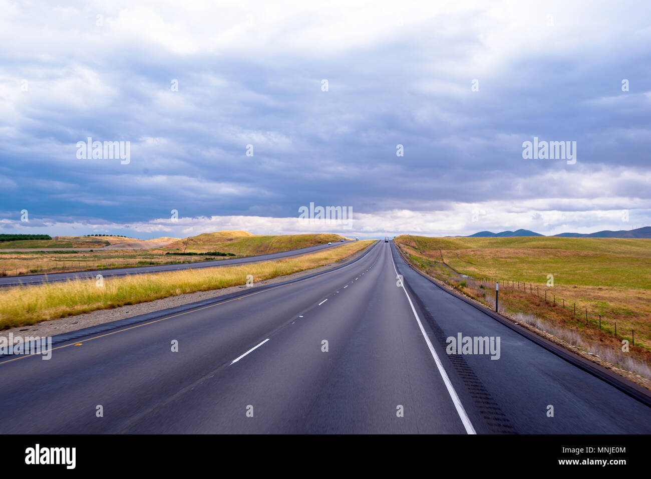 Infinite smooth straight divided interstate multiline highway road with ...