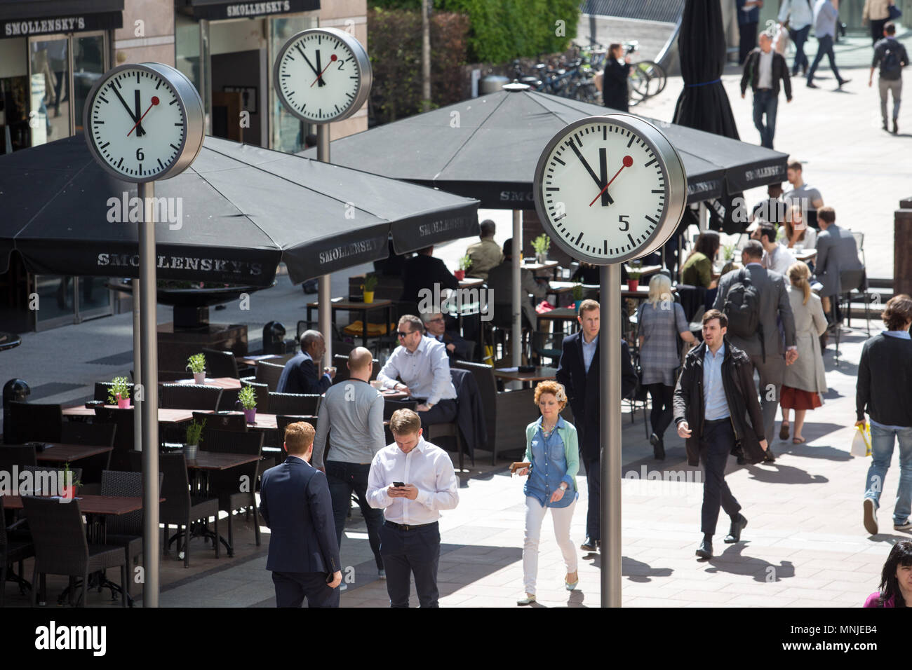 Canary Wharf, clocks show the time just before 12pm outside the ...