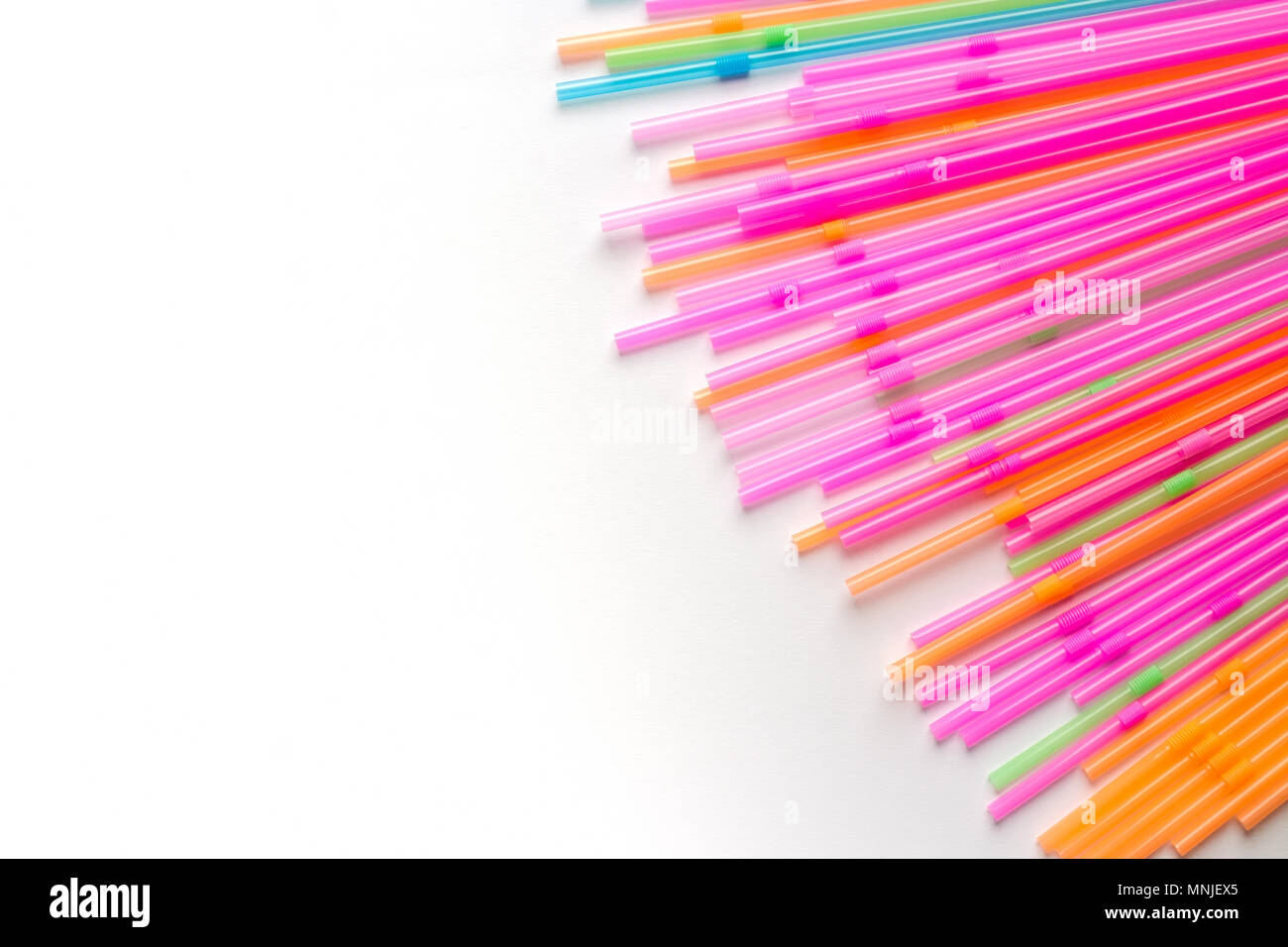 Pastel neon drinking straws on white background, isolated copy space ...