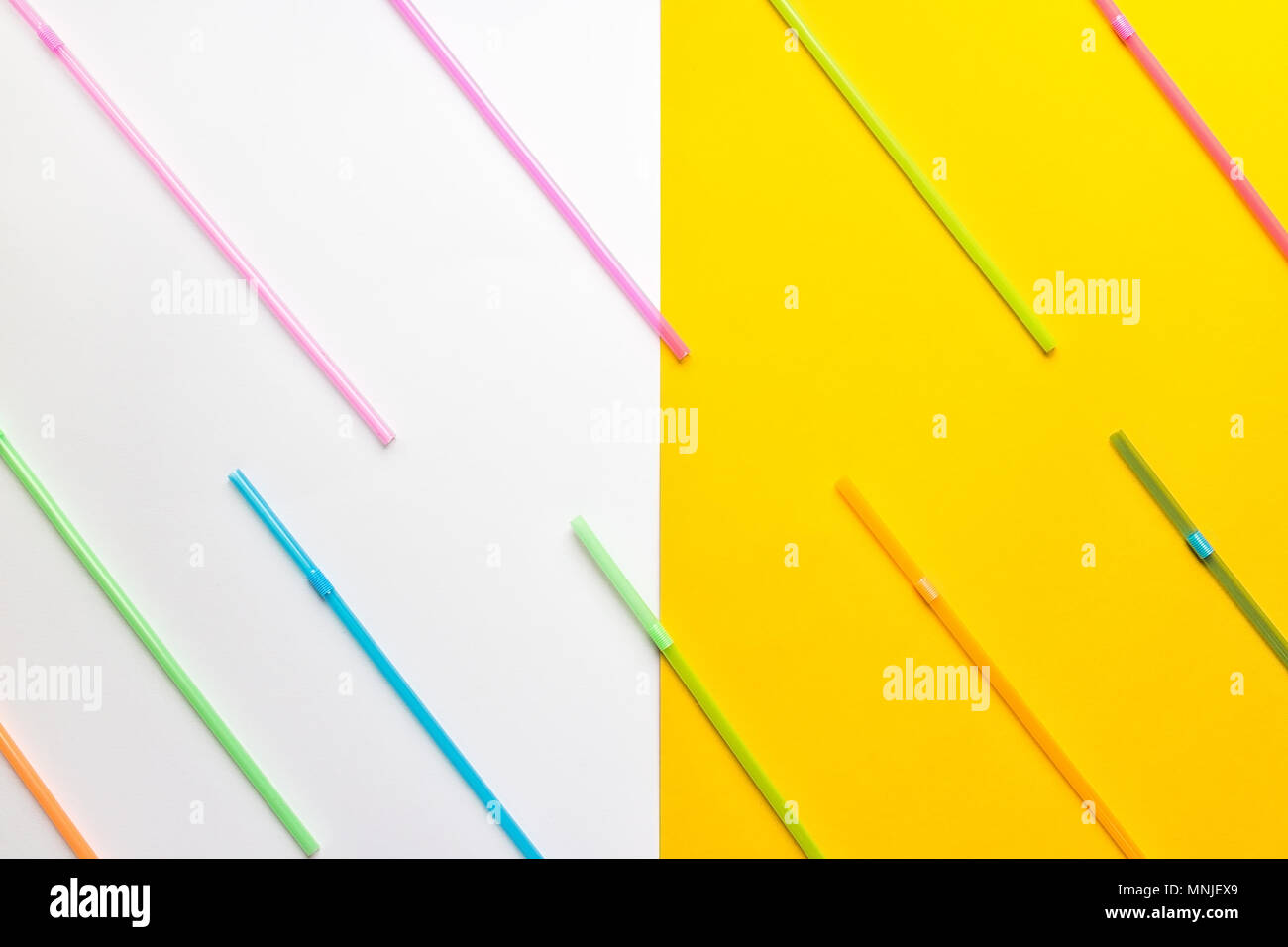 Pastel neon drinking straws isolated on white and yellow background ...