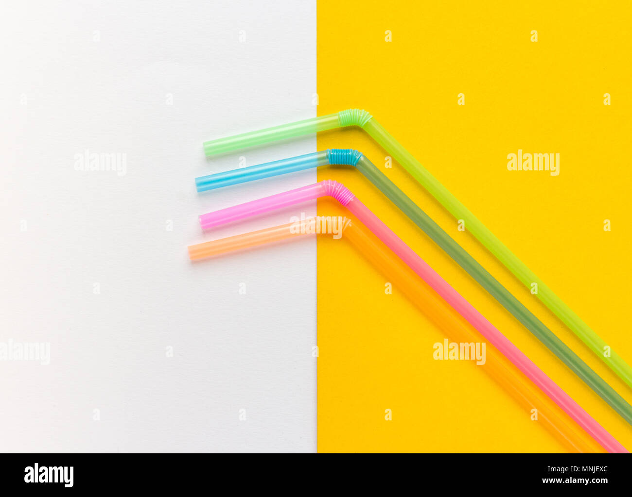 Pastel neon drinking straws isolated on white and yellow background ...