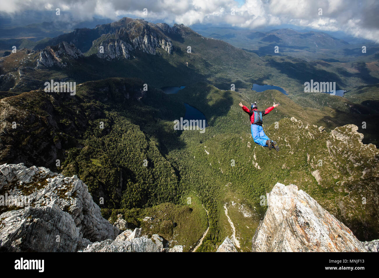 High angle view of BASE jumper in free fall right after jumping off ...