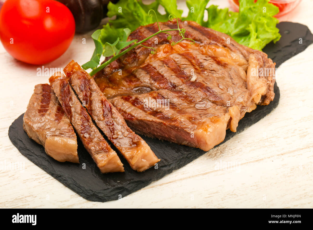Grilled Rib eye steak with sauce Stock Photo - Alamy