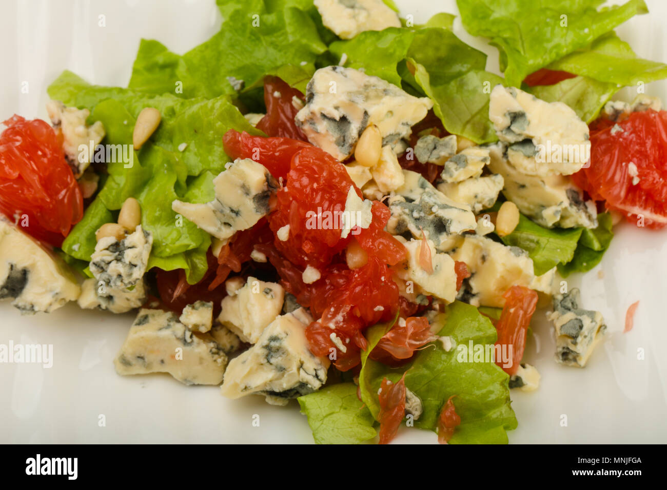 Grapefruit and blue cheese salad with cedar nut Stock Photo - Alamy