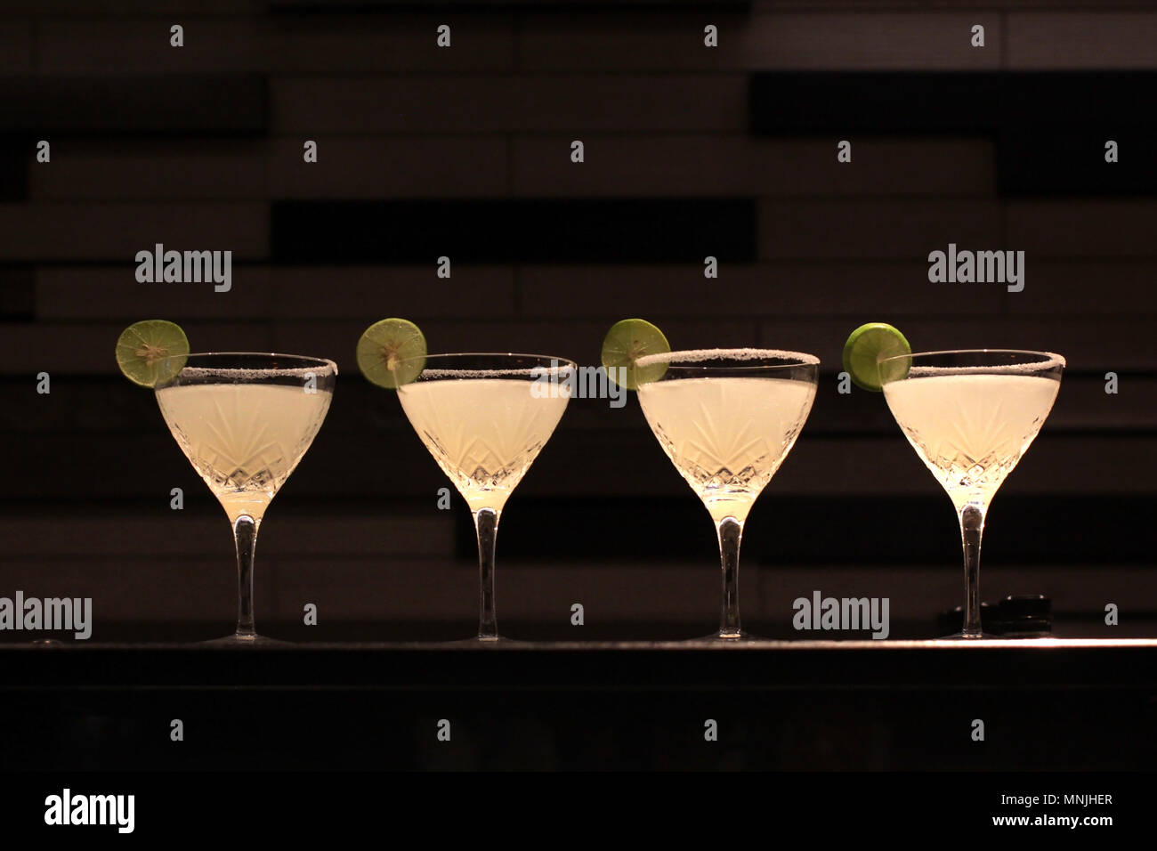 classic margarita cocktail with lime slice and salty rim Stock Photo ...