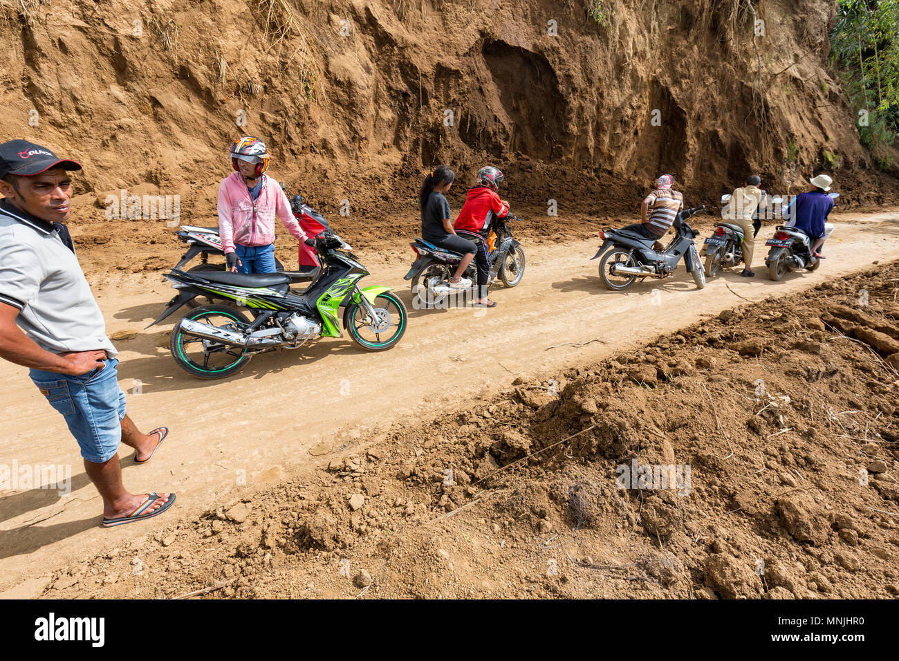MONI, INDONESIA - MAY 16: Unidentified people wait for construction at ...