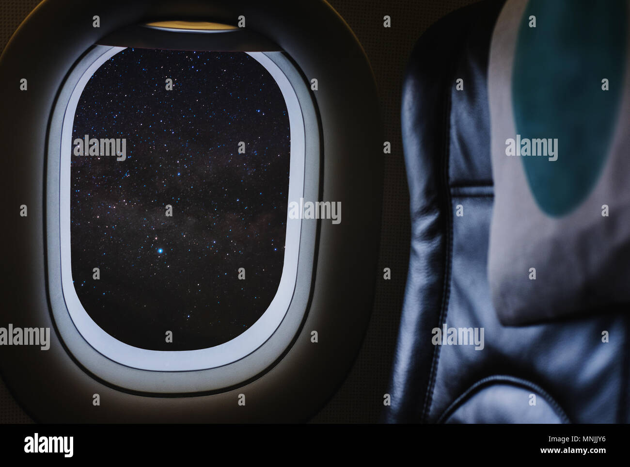 Travelling by air plane, looking through plane window enjoying ...