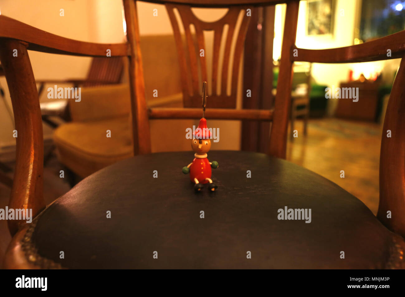 Pinocchio seating on the office chair Stock Photo - Alamy