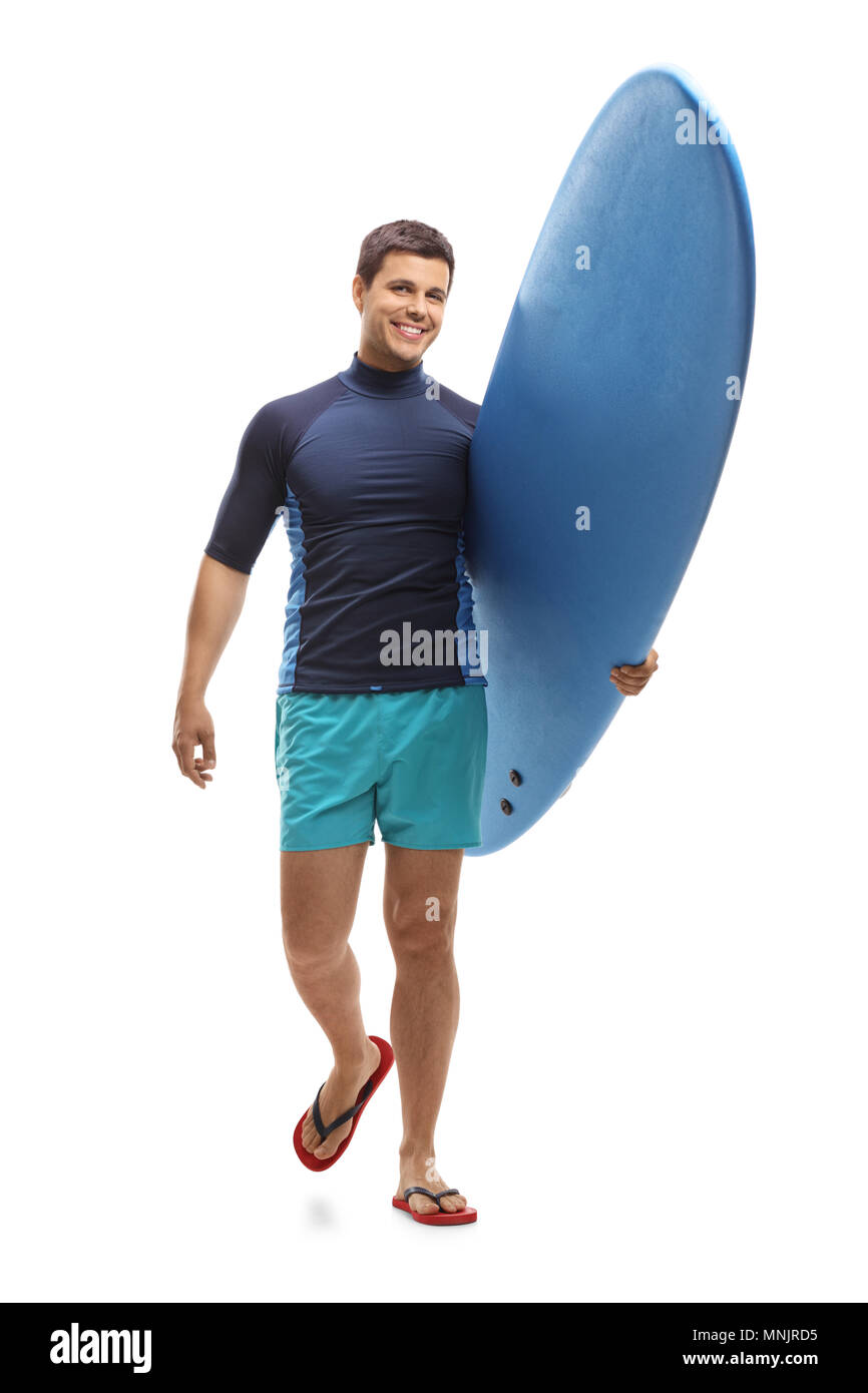 Full length portrait of a surfer holding a surfboard and walking ...
