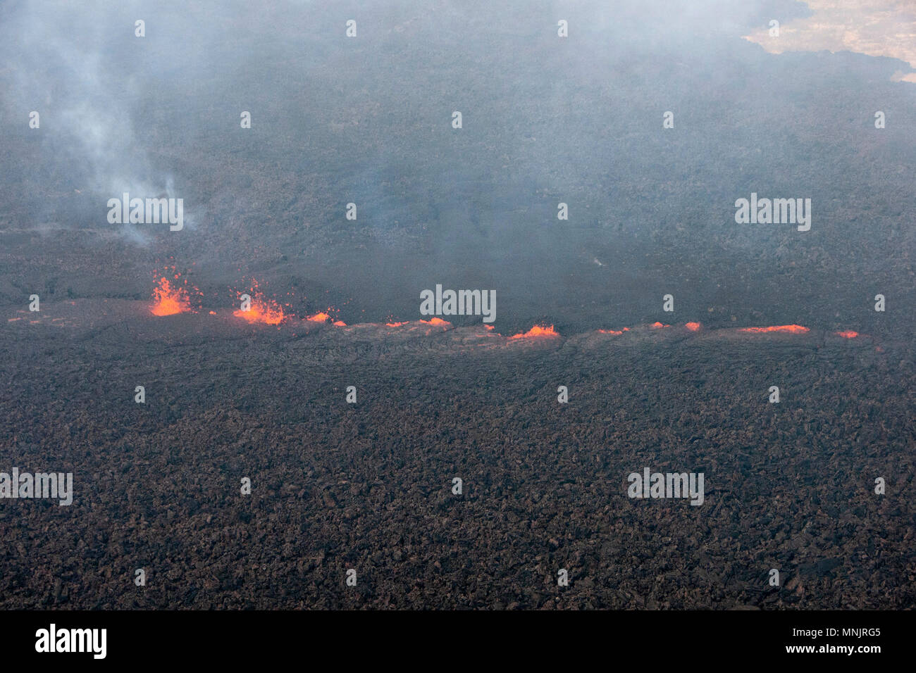 Lava and poison gases bubble out from a fissure caused by the eruption ...