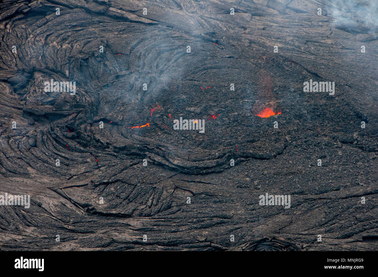 Lava and poison gases bubble out from a fissure caused by the eruption ...