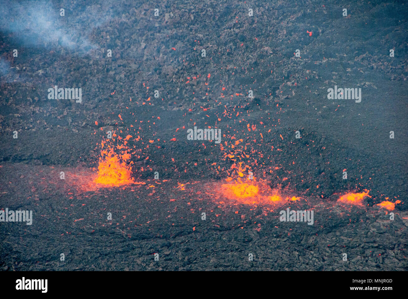 Lava and poison gases bubble out from a fissure caused by the eruption ...