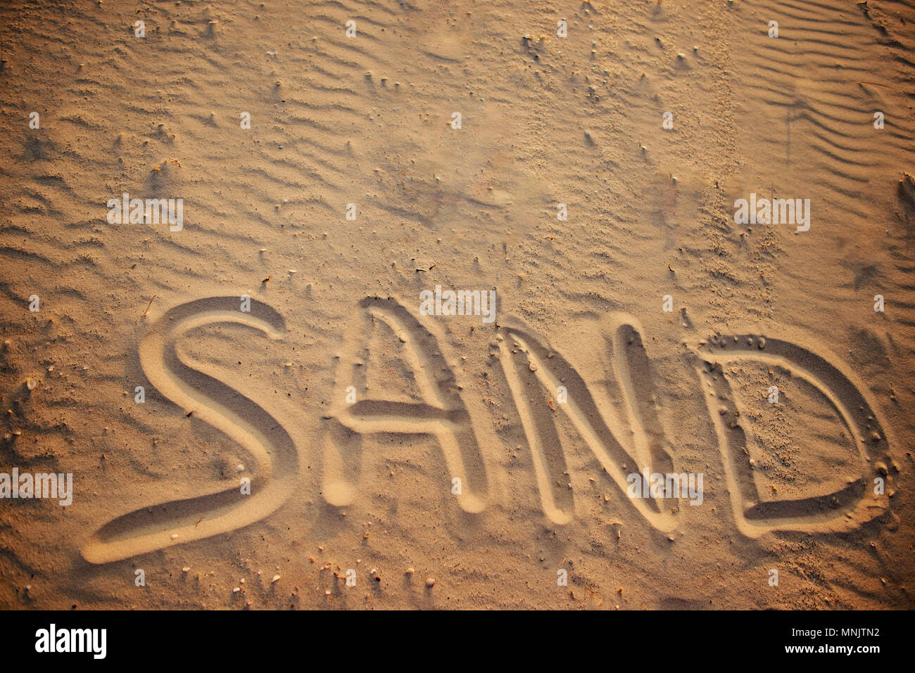 the word beach is written in the sand Stock Photo - Alamy