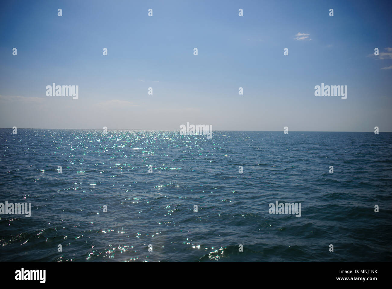 the blue ocean with dull clouds on a lovely sunny day Stock Photo - Alamy