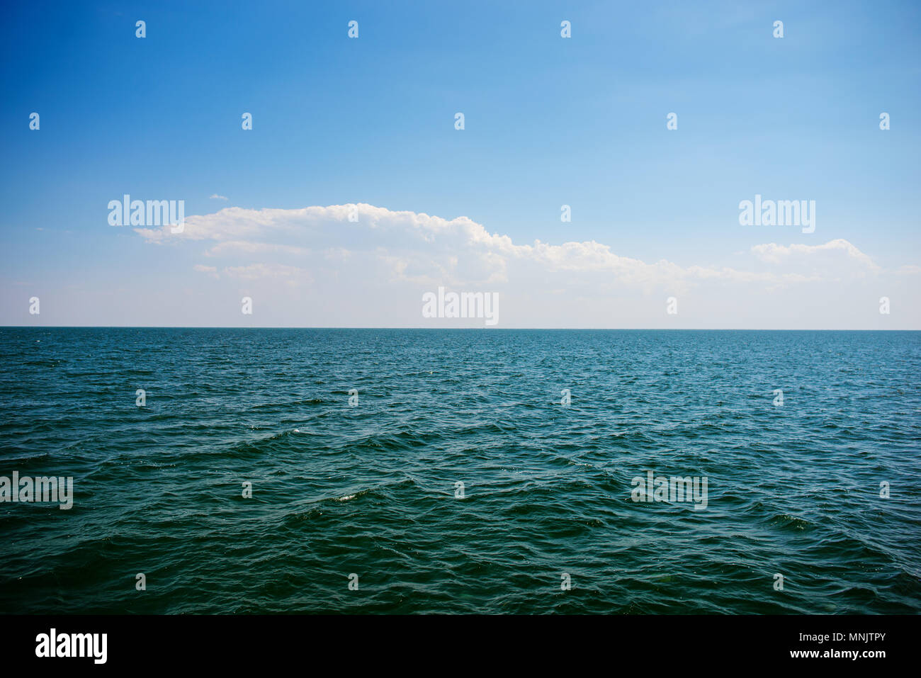 the blue ocean with dull clouds on a lovely sunny day Stock Photo - Alamy