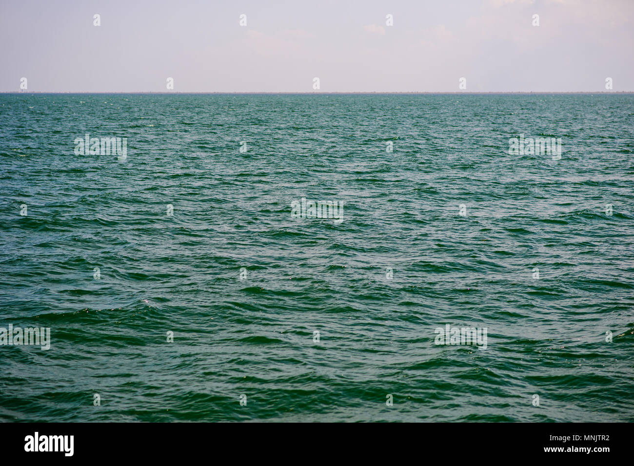 the blue ocean with dull clouds on a lovely sunny day Stock Photo - Alamy
