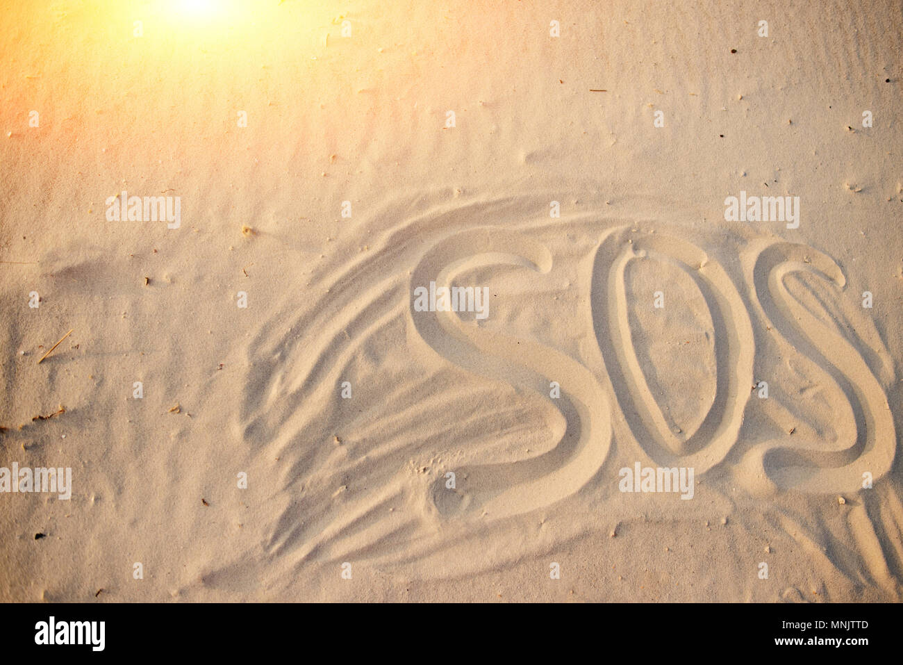 The inscription on the sand beach SOS Stock Photo - Alamy