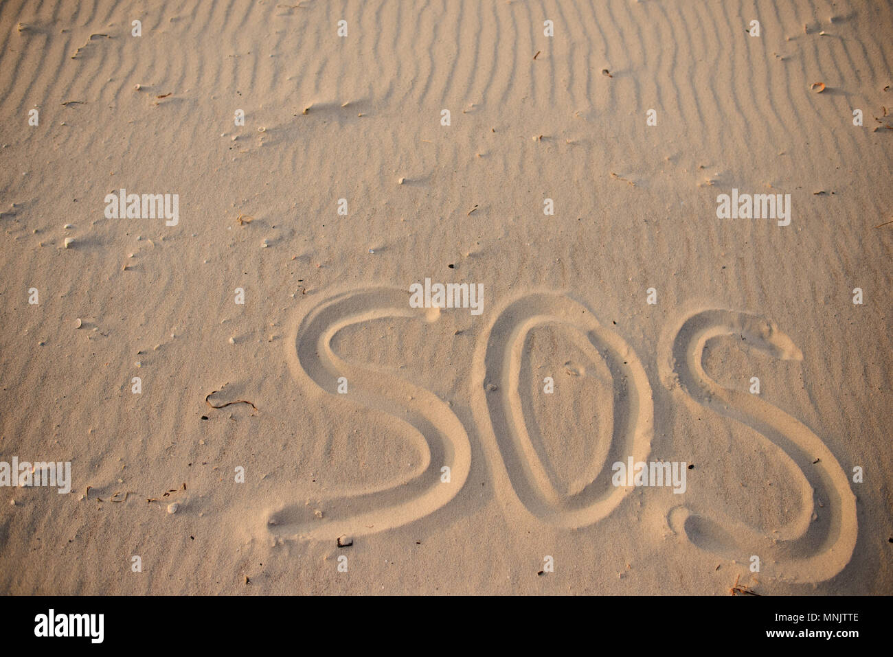 The inscription on the sand beach SOS Stock Photo - Alamy