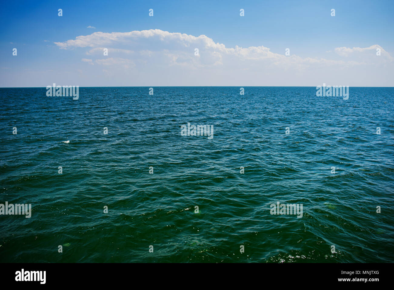 the blue ocean with dull clouds on a lovely sunny day Stock Photo - Alamy