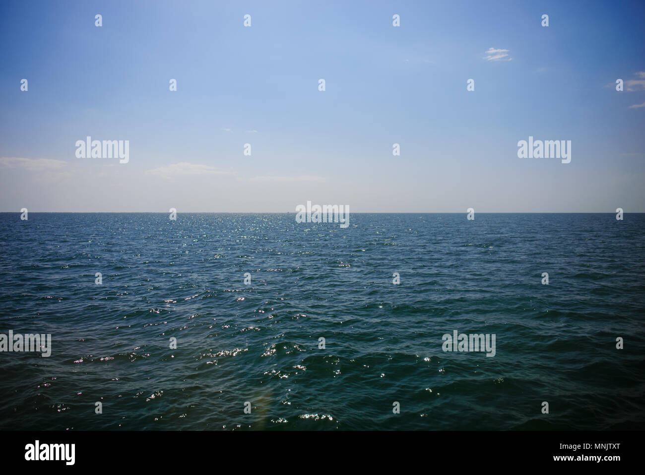 the blue ocean with dull clouds on a lovely sunny day Stock Photo - Alamy