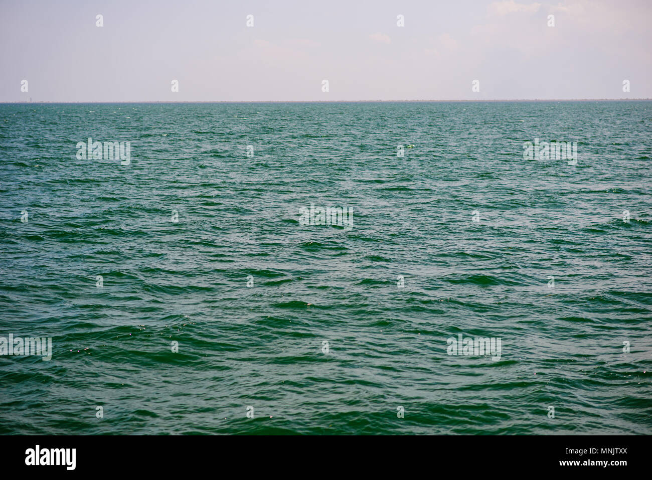 the blue ocean with dull clouds on a lovely sunny day Stock Photo - Alamy