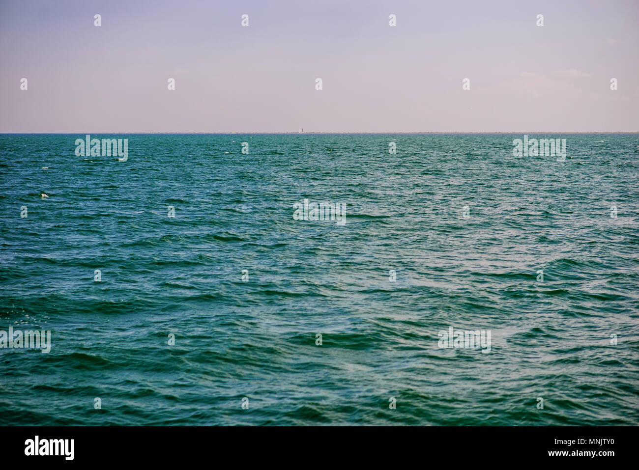 the blue ocean with dull clouds on a lovely sunny day Stock Photo - Alamy