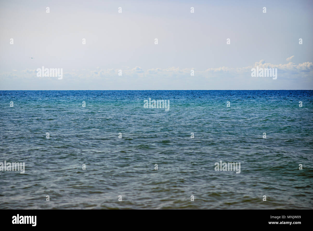 the blue ocean with dull clouds on a lovely sunny day Stock Photo - Alamy