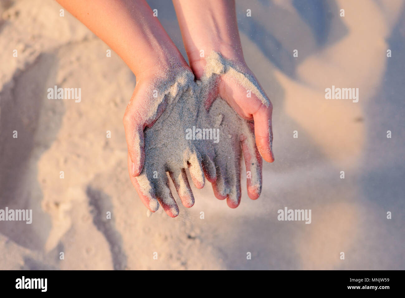 Hand pours sand beach hi-res stock photography and images - Alamy