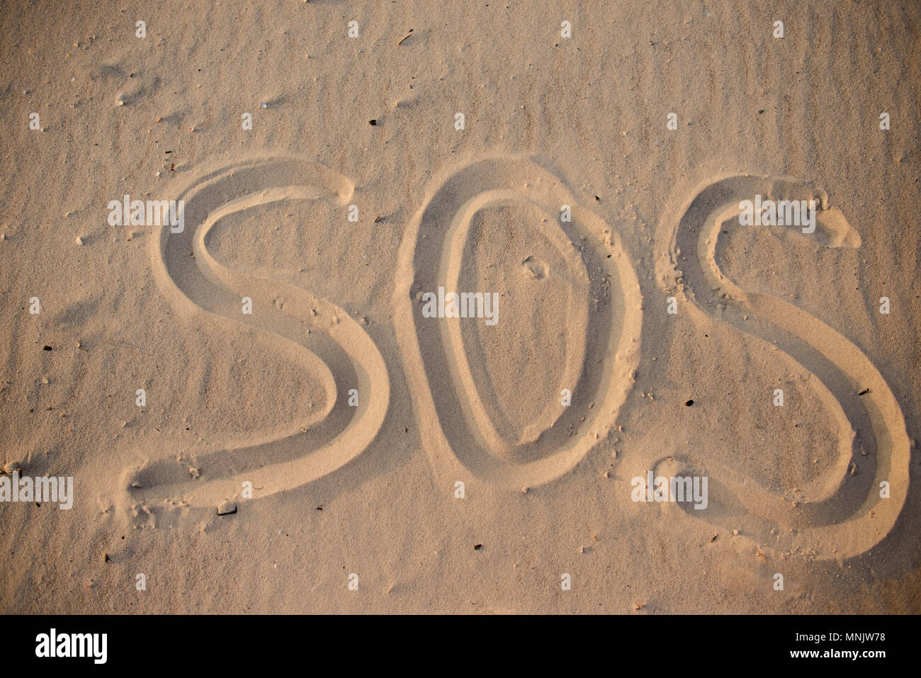 The inscription on the sand beach SOS Stock Photo - Alamy