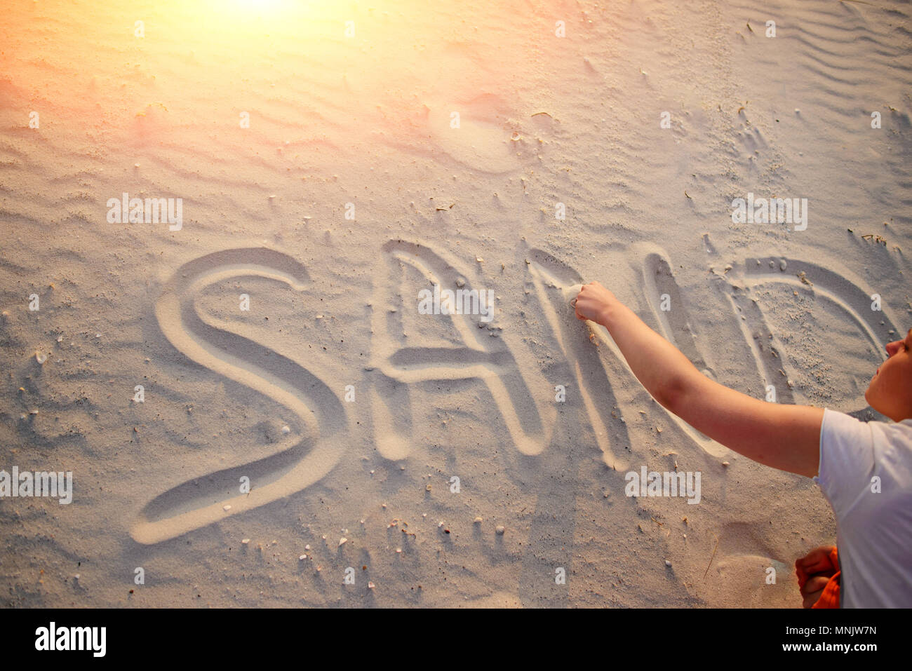 the word beach is written in the sand Stock Photo - Alamy