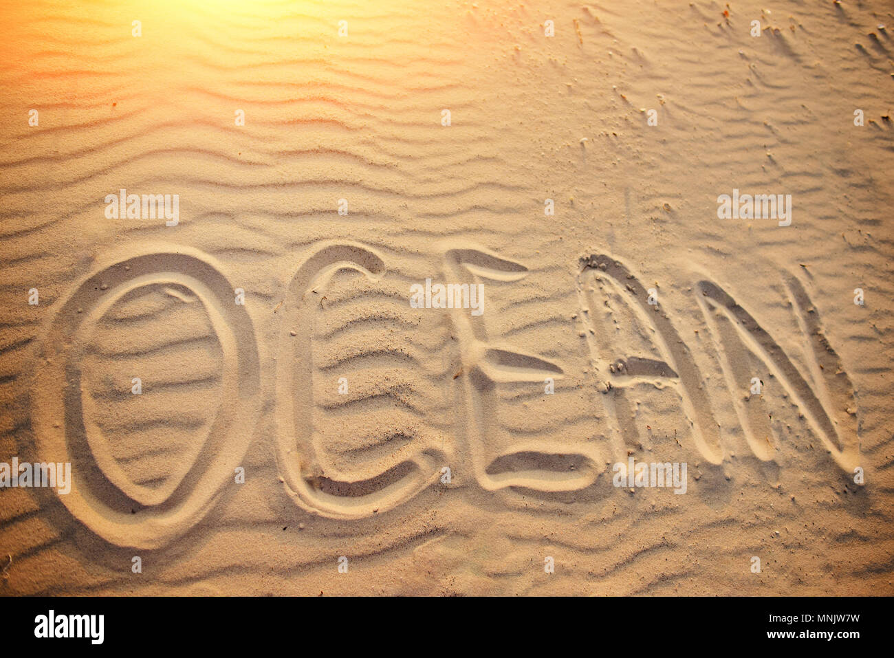 the word beach is written in the sand Stock Photo - Alamy