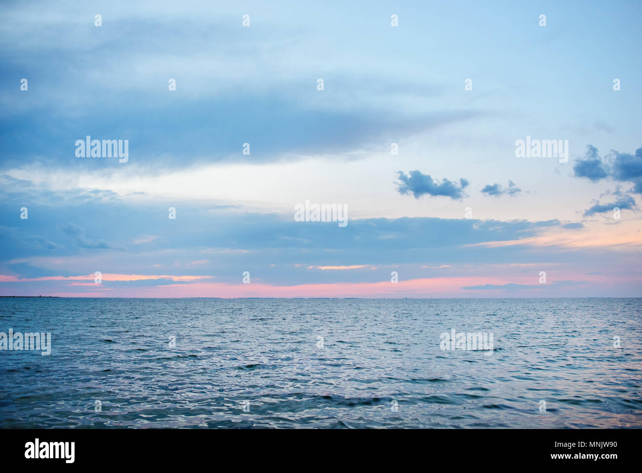 the blue ocean with dull clouds on a lovely sunny day Stock Photo - Alamy