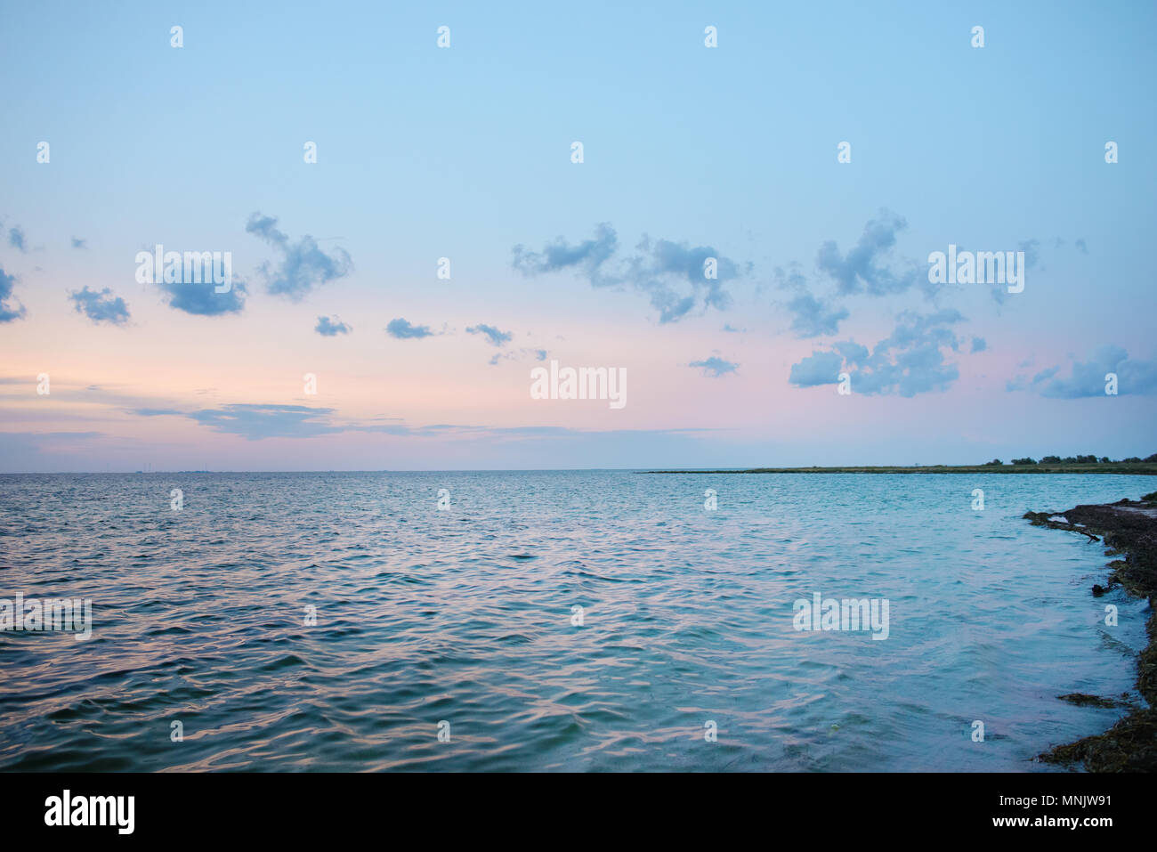 the blue ocean with dull clouds on a lovely sunny day Stock Photo - Alamy