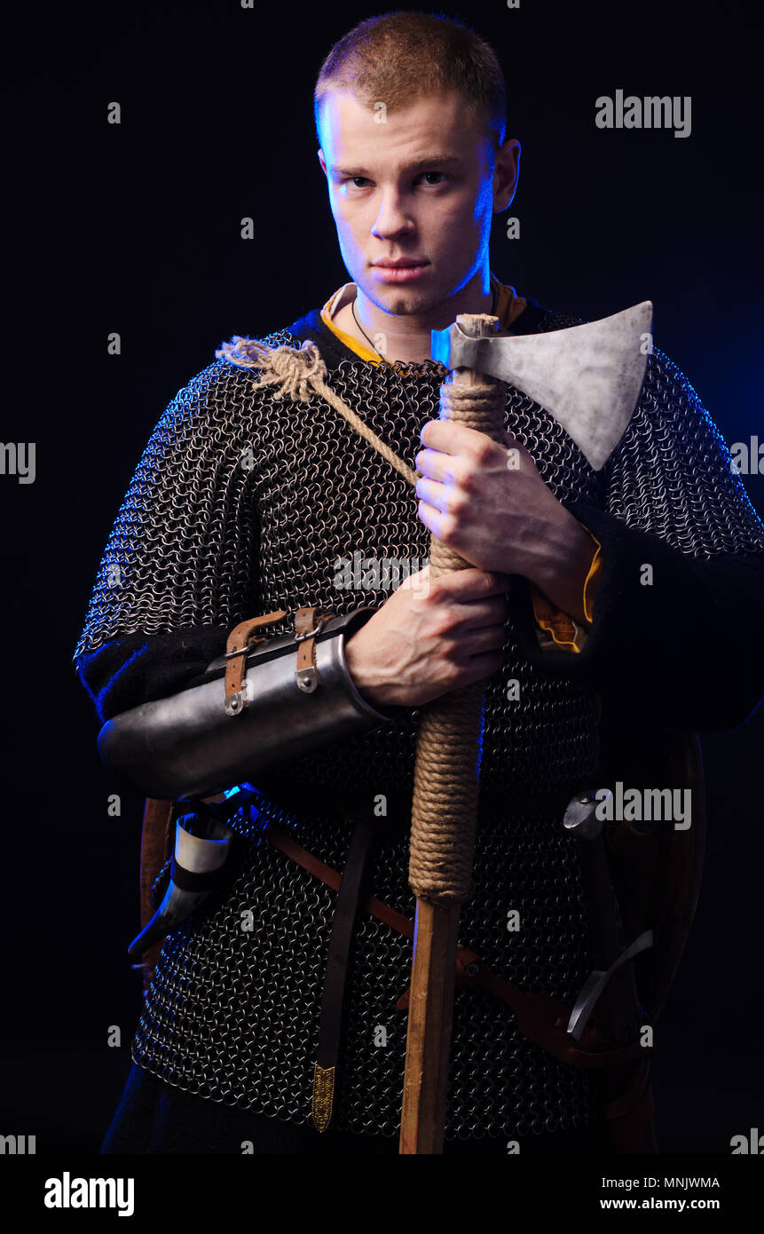 Male medieval warrior in armour and chain mail, viking with battle ax ...