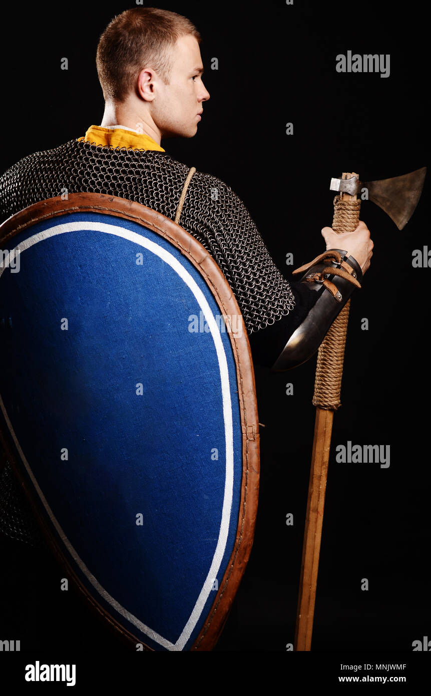 Warrior Stand his back to the camera with a shield on his back and an ...