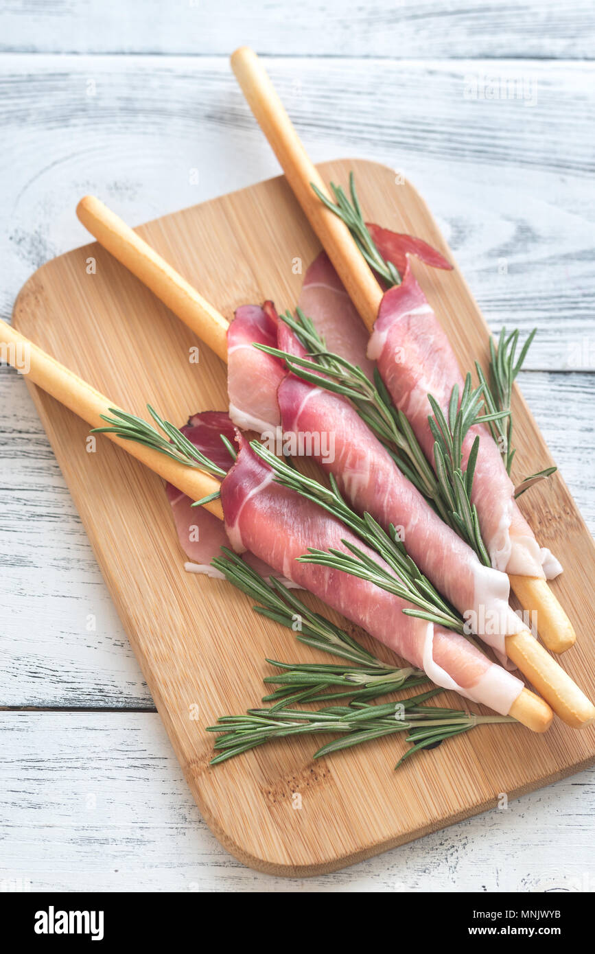 Breadsticks wrapped in ham Stock Photo - Alamy