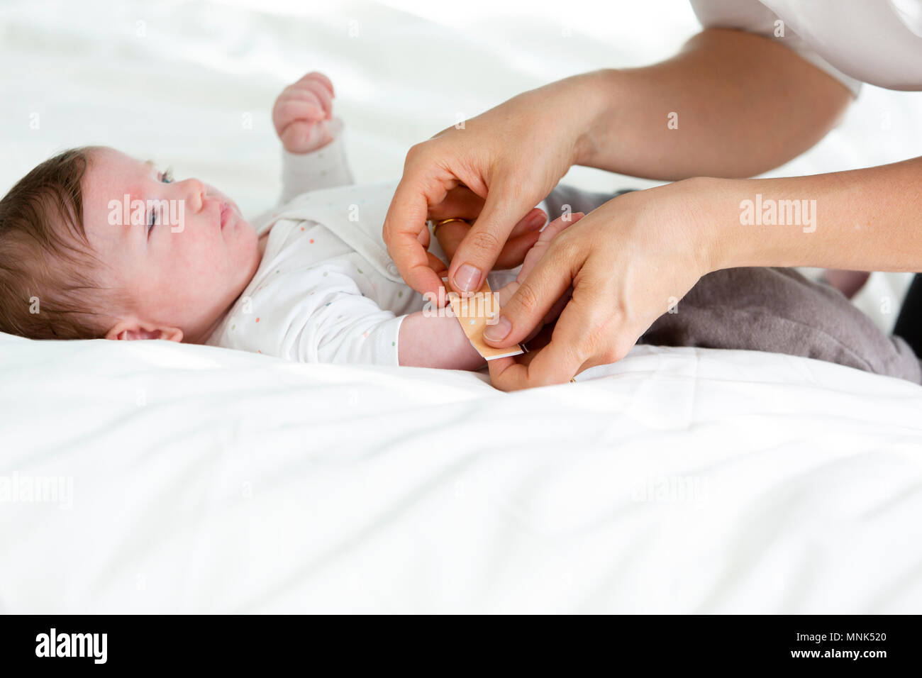 Woman putting on plaster hi-res stock photography and images - Alamy