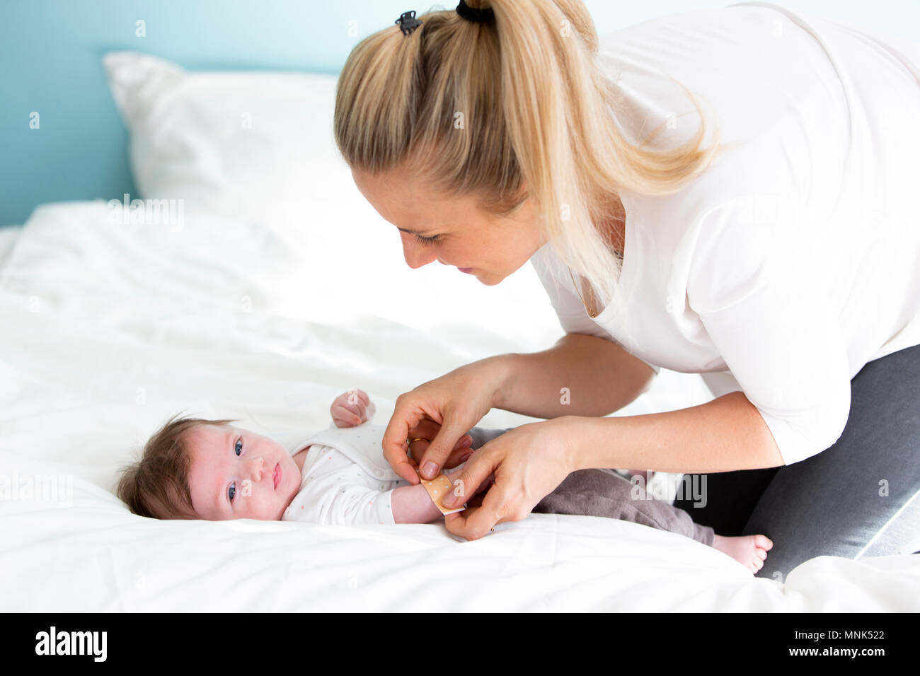 Mum putting plaster on child hi-res stock photography and images - Alamy