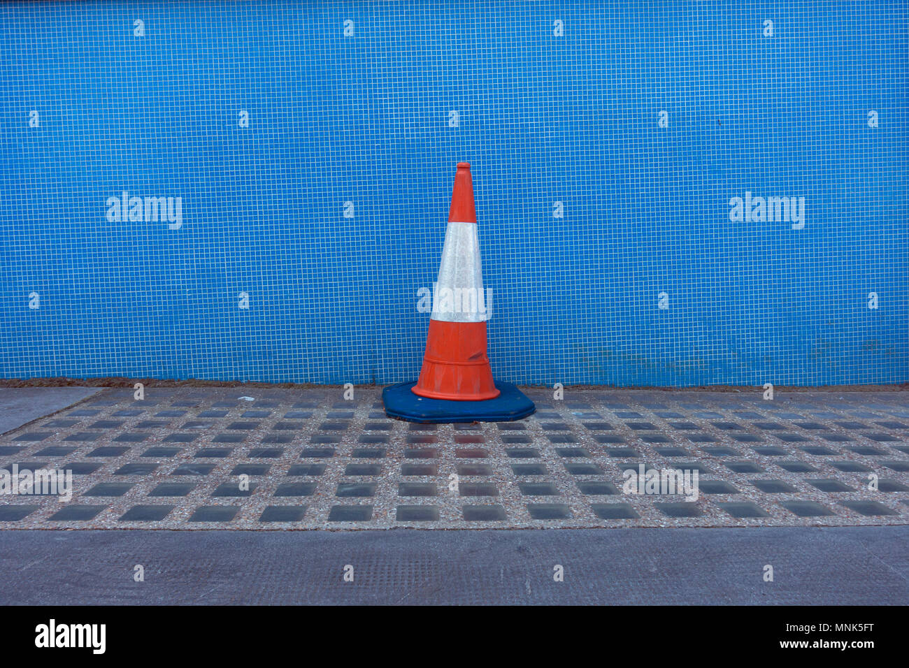 A traffic cone against a wall Stock Photo - Alamy
