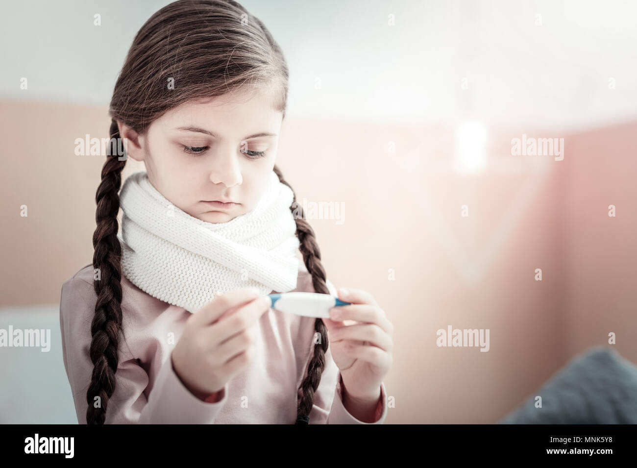 Upset child worrying about her health Stock Photo - Alamy