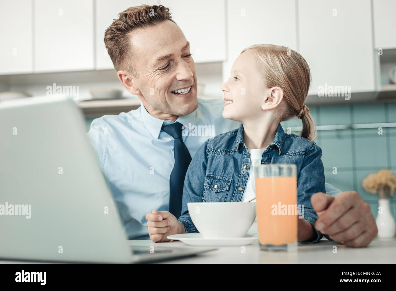 Happy family having friendly talk in the kitchen Stock Photo - Alamy