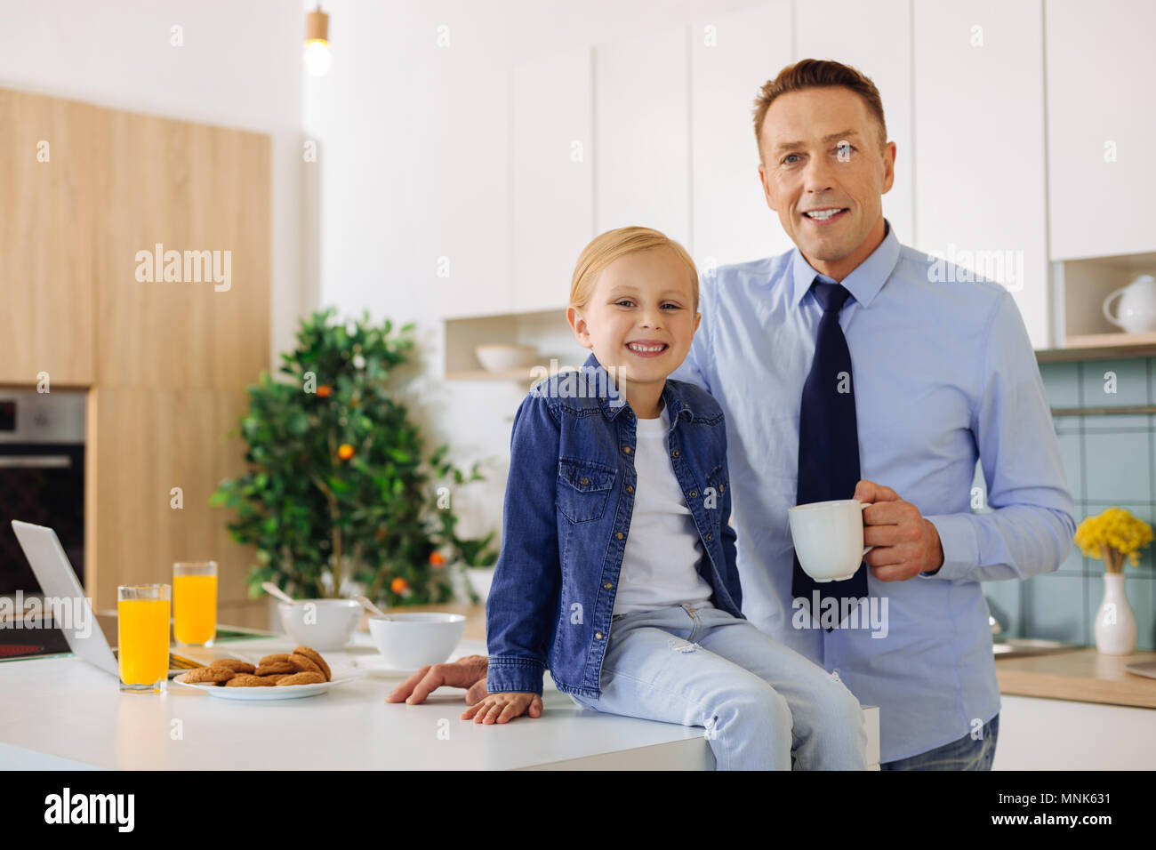 Positive delighted father and kid posing on camera Stock Photo - Alamy