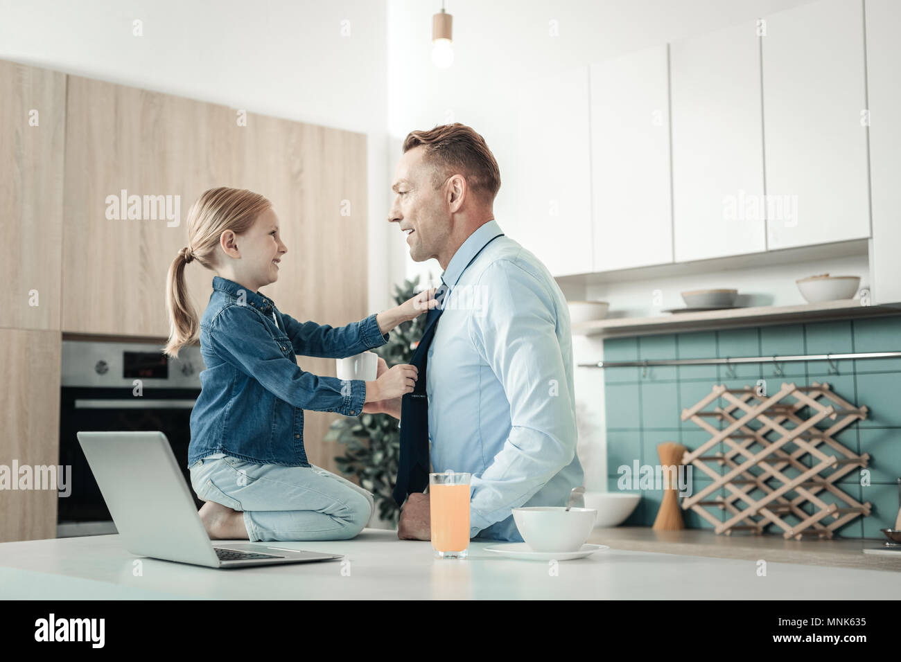 Positive young man looking at his kid Stock Photo - Alamy