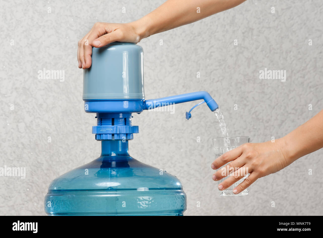 Hand pouring water from bottle hi-res stock photography and images - Alamy