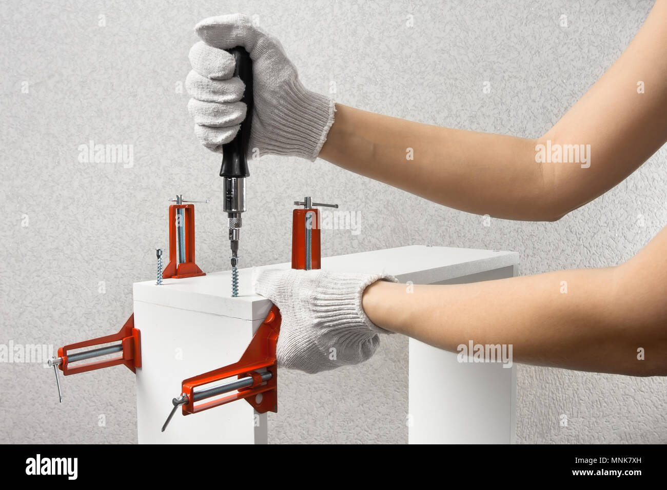 Assembling hand hi-res stock photography and images - Alamy