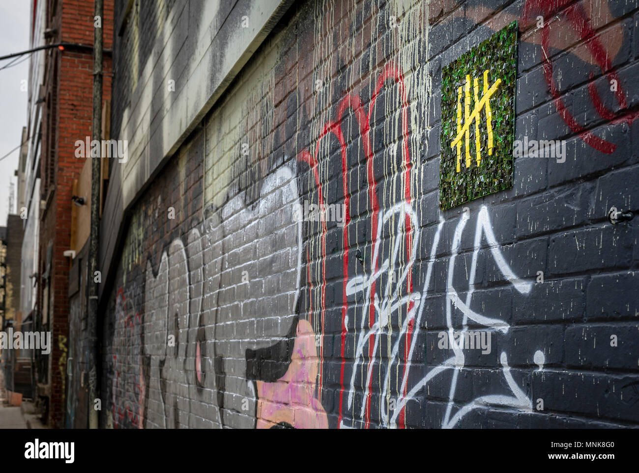 Mosaic graffiti by street artist Mark Tally displayed on the walls of ...