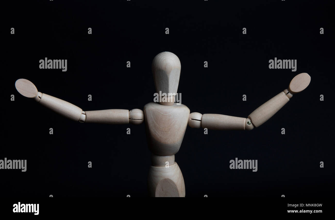 wooden mannequin arms spread blach background Stock Photo - Alamy