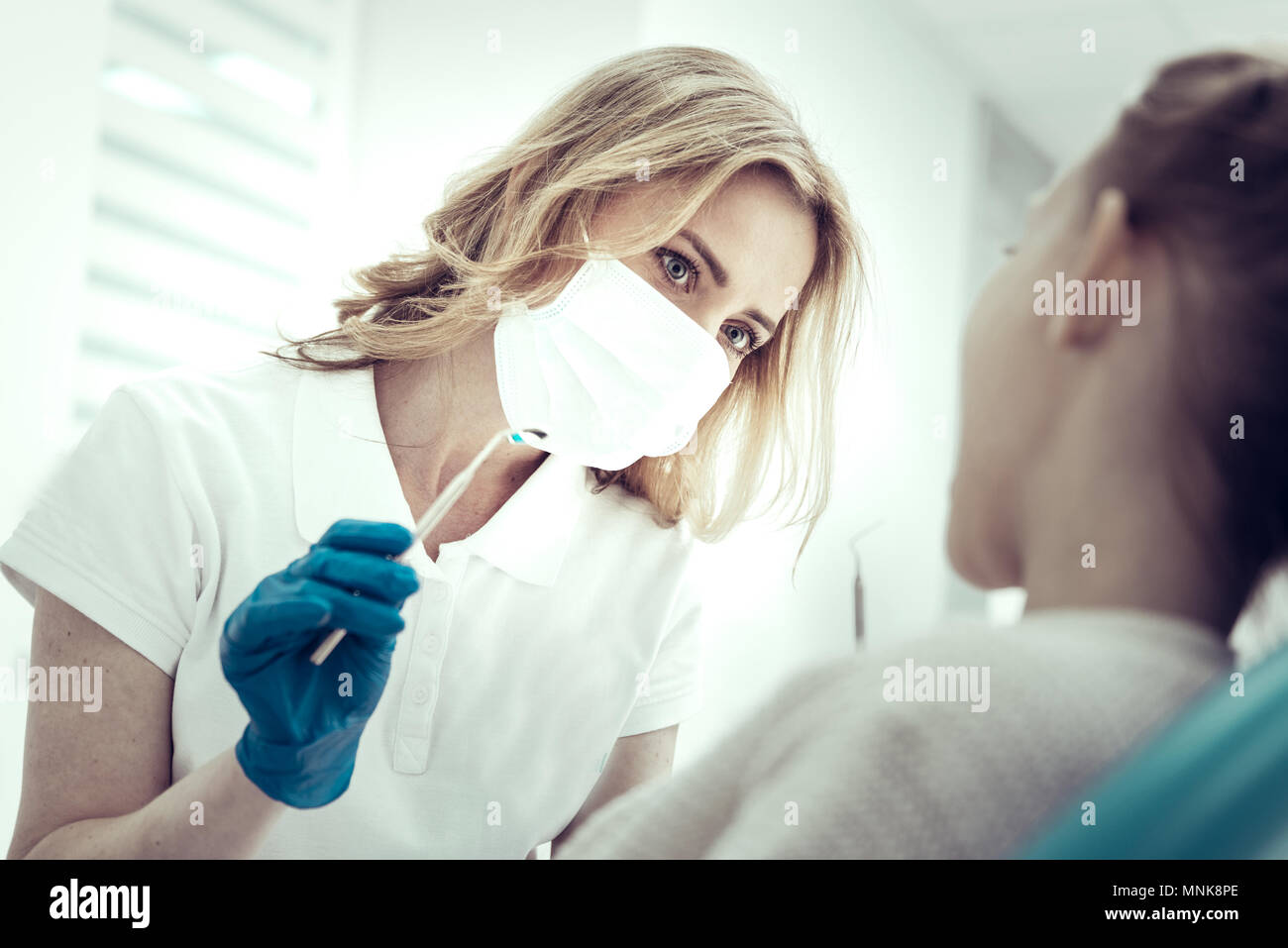 Kind doctor looking at her patient Stock Photo - Alamy