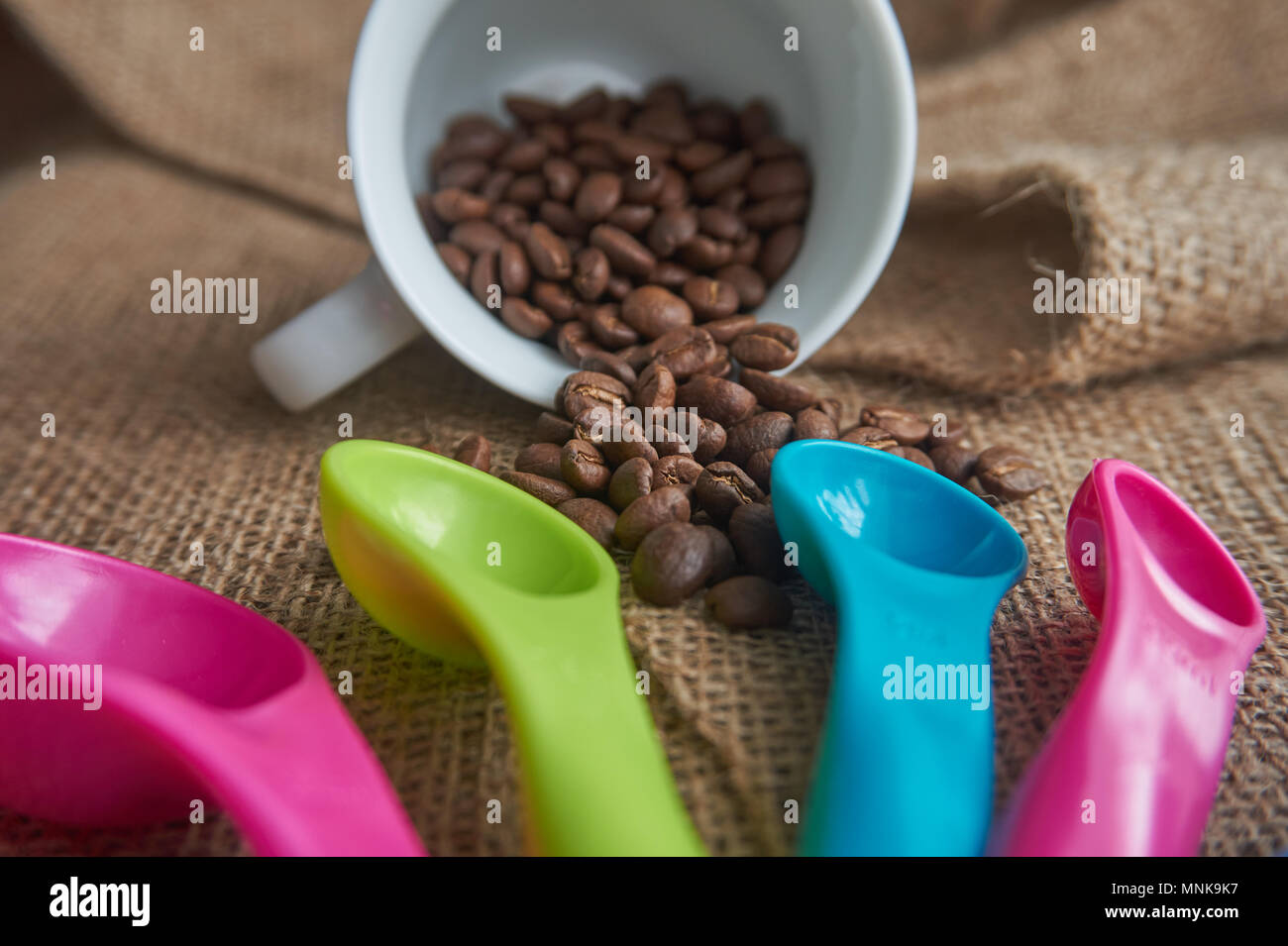 Loose roasted coffee beans, white porcelain coffee mug and color ...